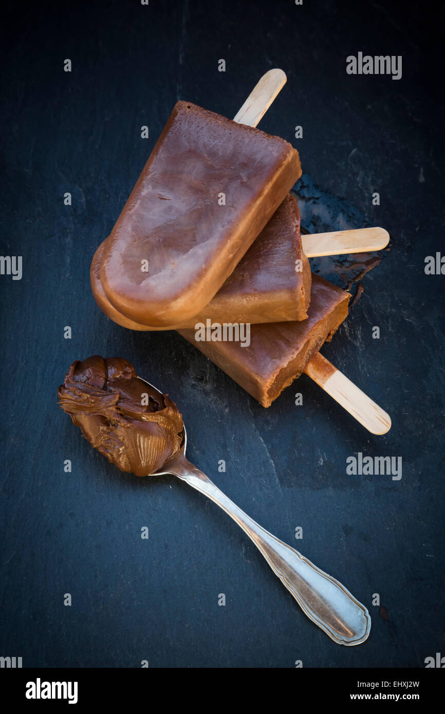 Nutella popsicle, spoon with Nutella on slate Stock Photo - Alamy