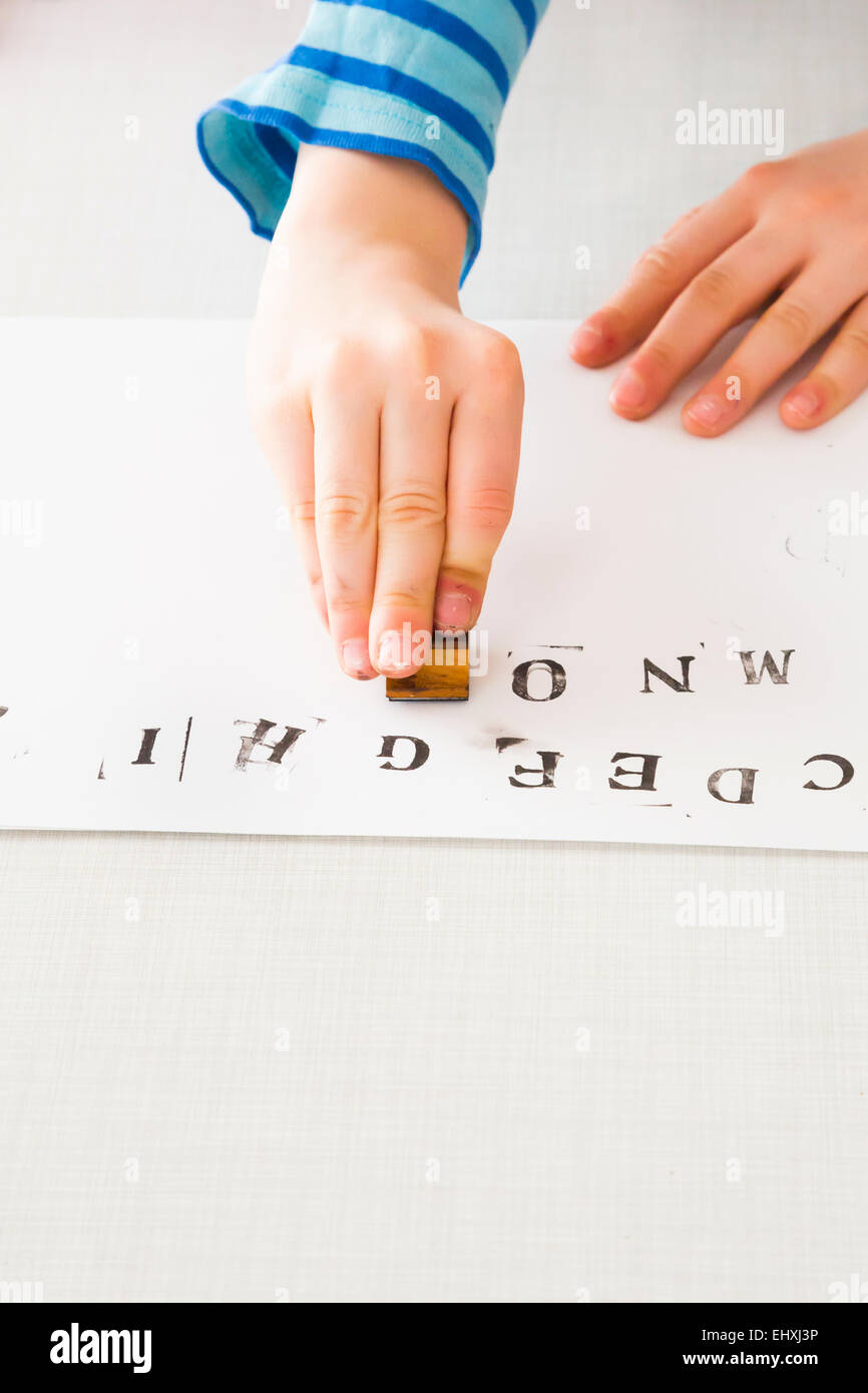 Girl's hand with letter stamp Stock Photo - Alamy