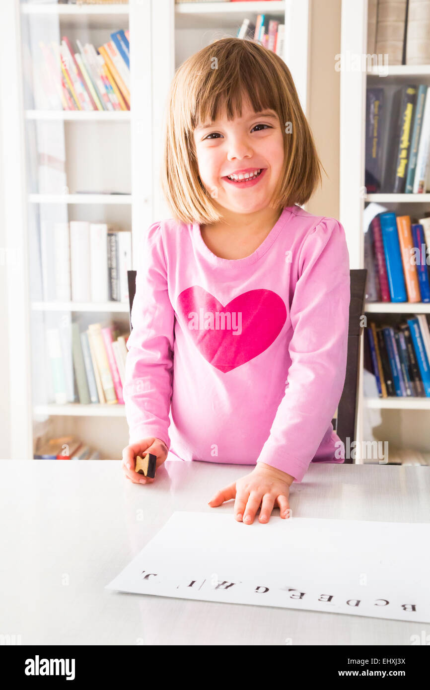 Portrait of smiling girl with stamp Stock Photo - Alamy