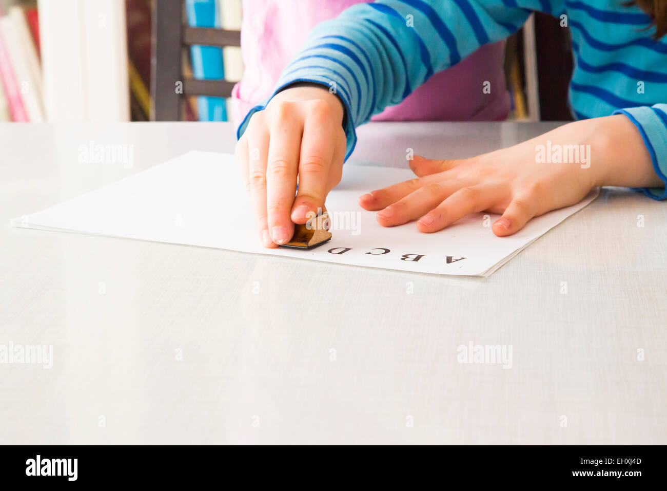 Girl using letter stamp Stock Photo - Alamy