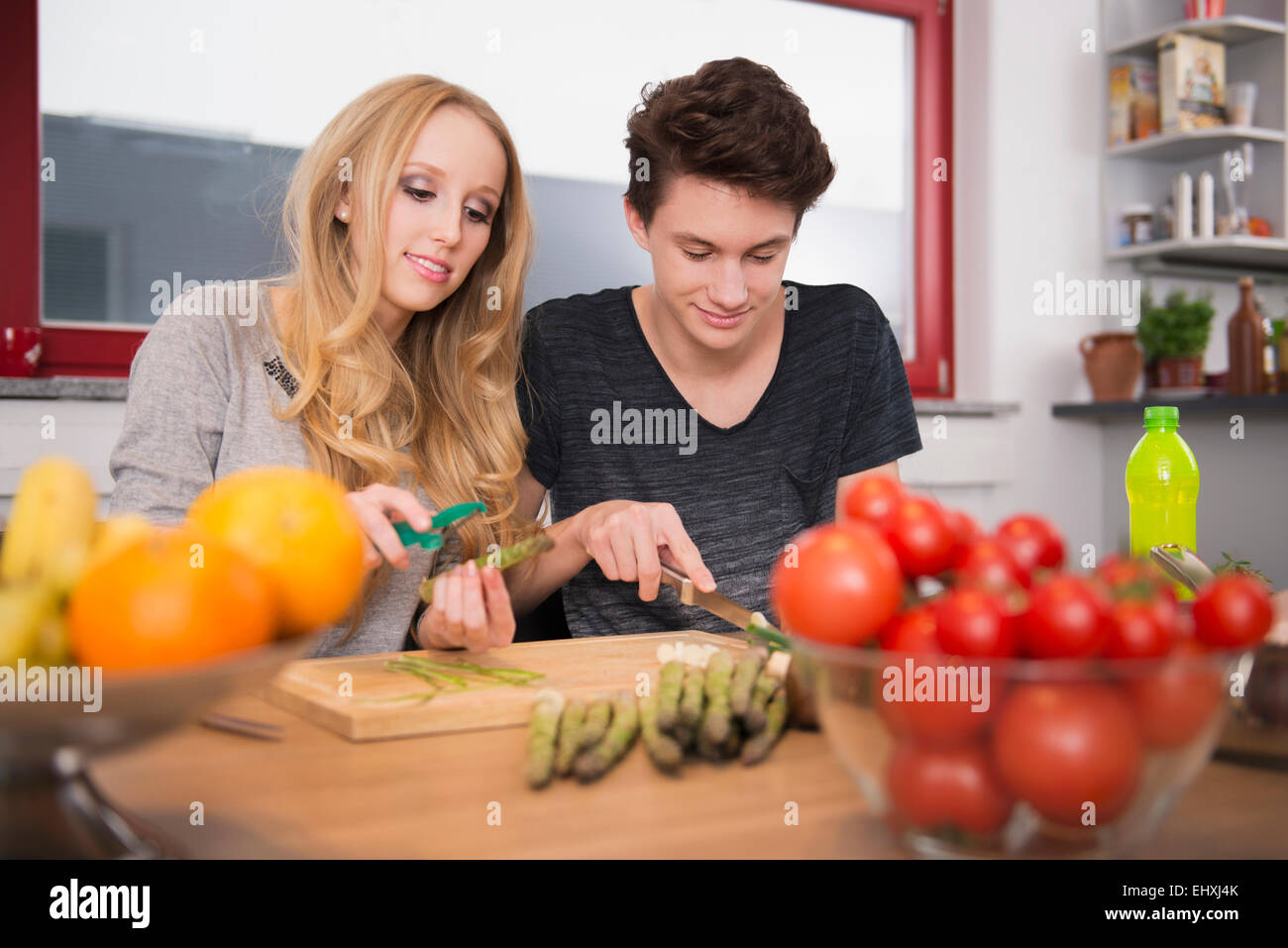 Couple preparing food in kitchen, Munich, Bavaria, Germany Stock Photo ...