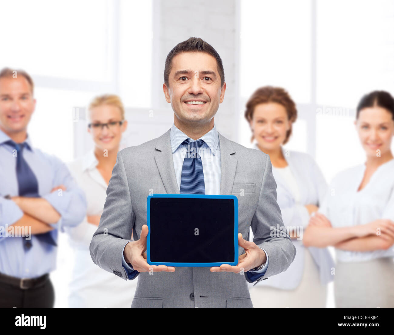 happy businessman in suit showing tablet pc screen Stock Photo - Alamy