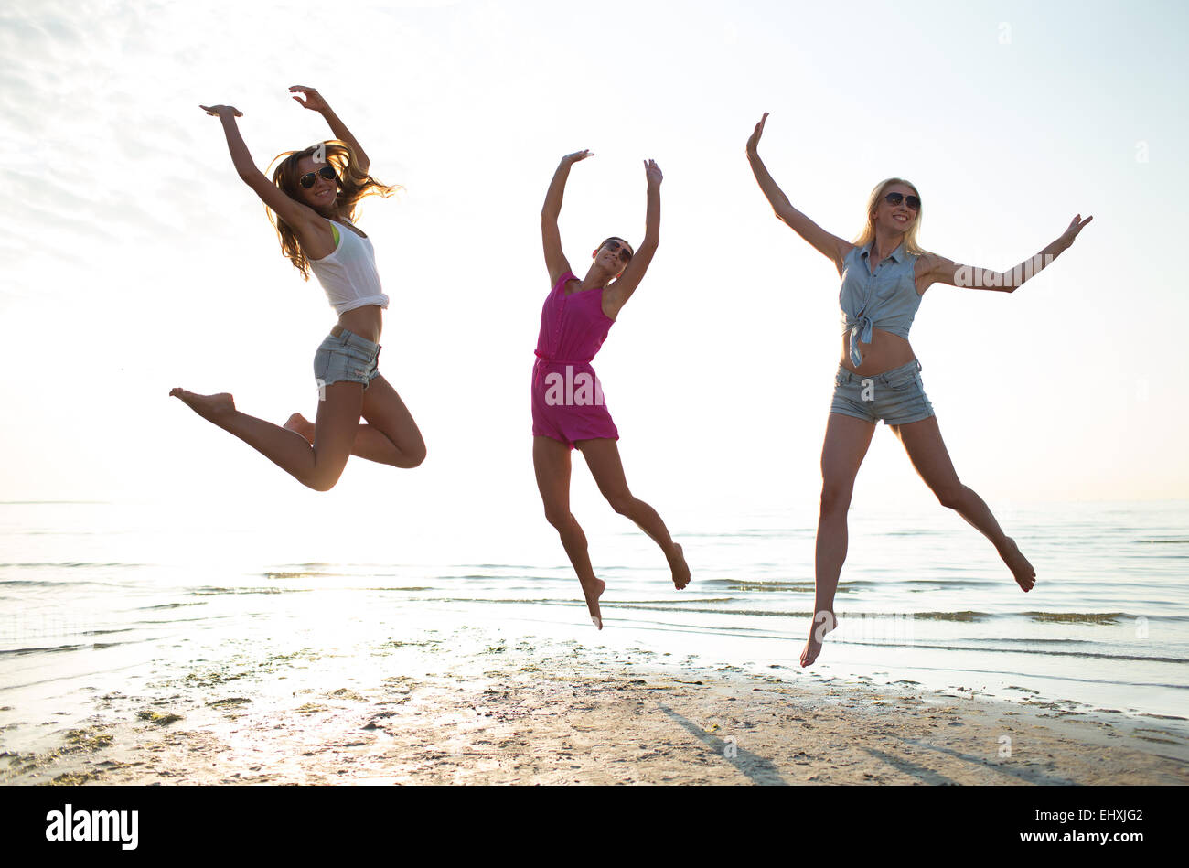 Happy women jumping hi-res stock photography and images - Alamy