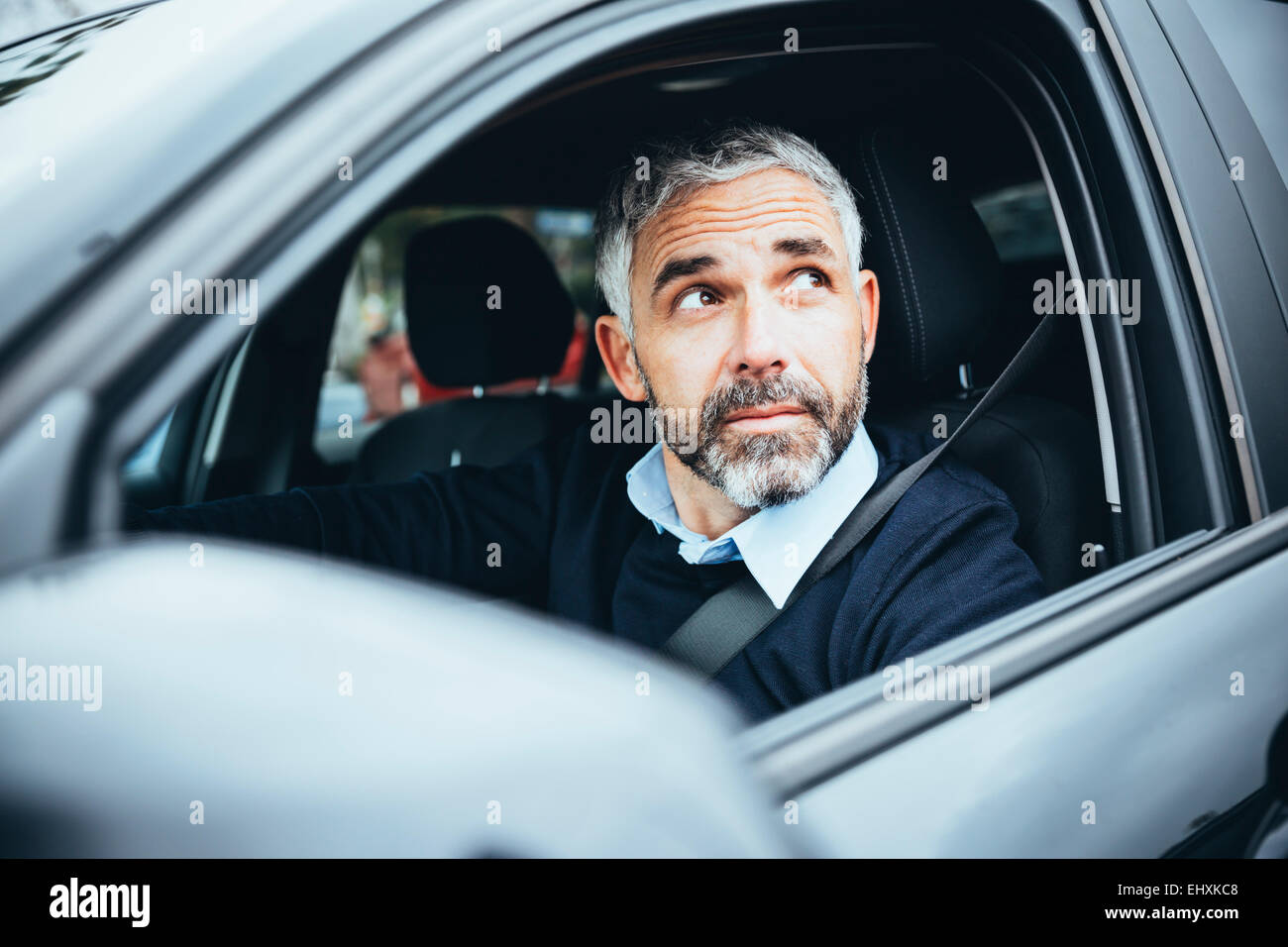 Man in car looking up Stock Photo - Alamy