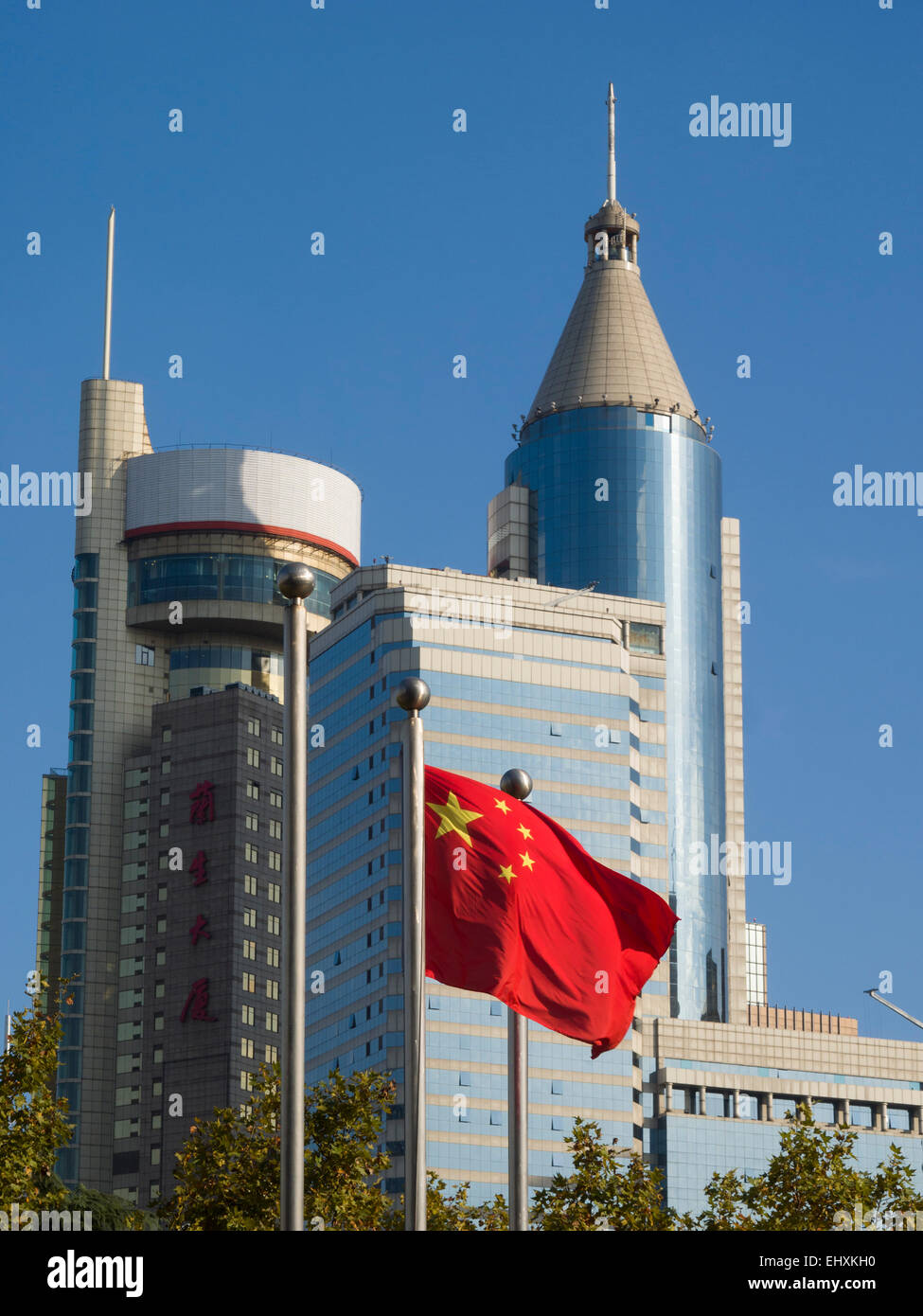 Chinese flag in front of a building with peculiar design in Shanghai ...