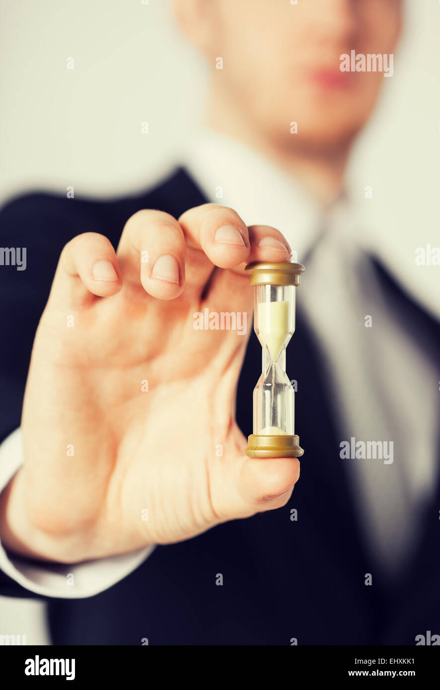 man hand holding hourglass Stock Photo - Alamy