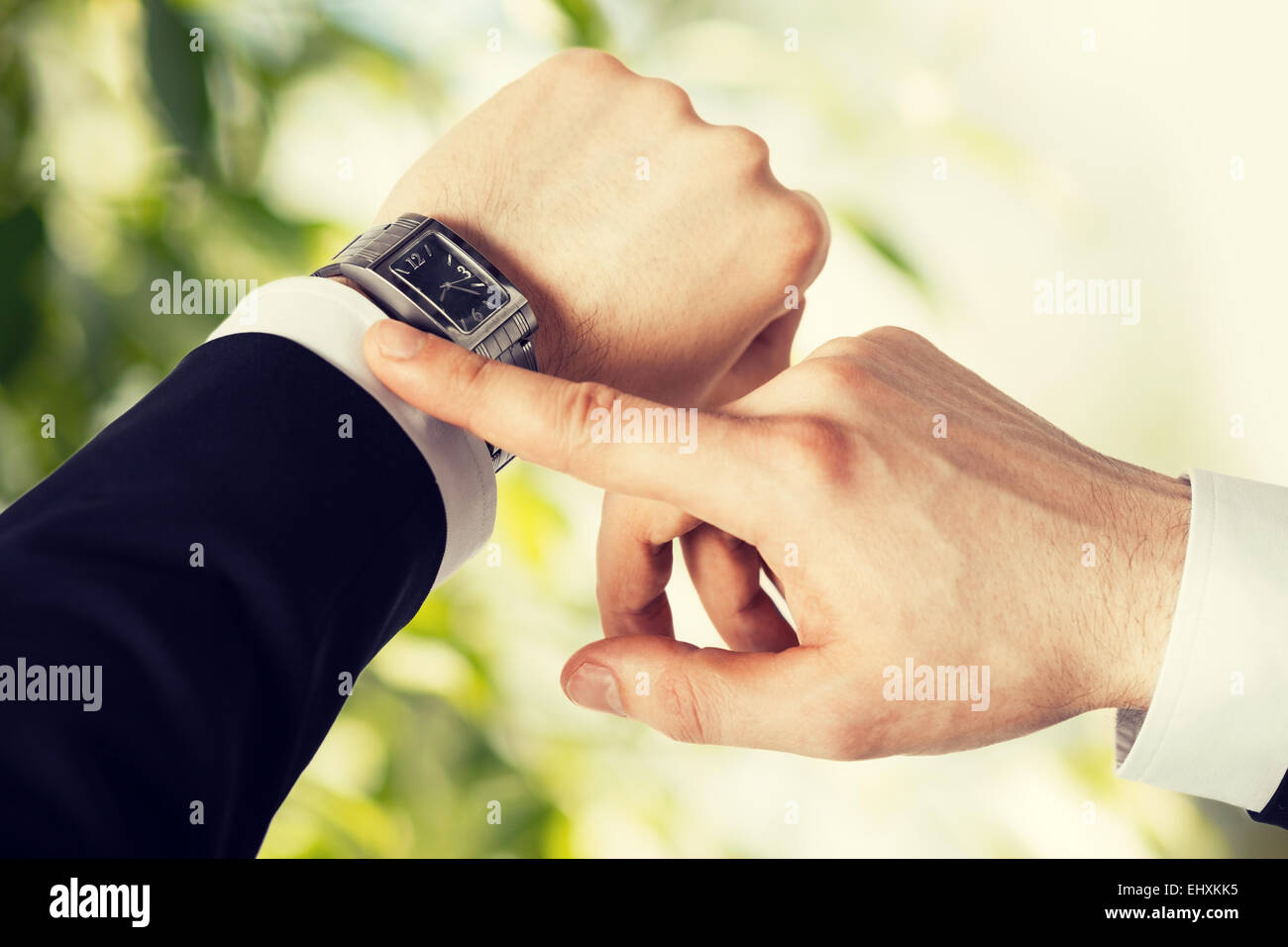 man looking at wristwatch Stock Photo - Alamy