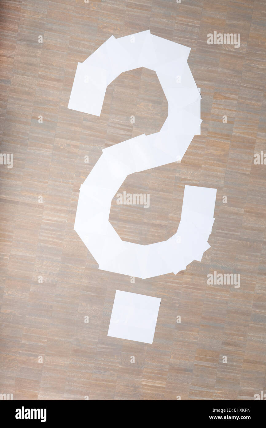Sheets of paper in shape of question mark on floor Stock Photo - Alamy