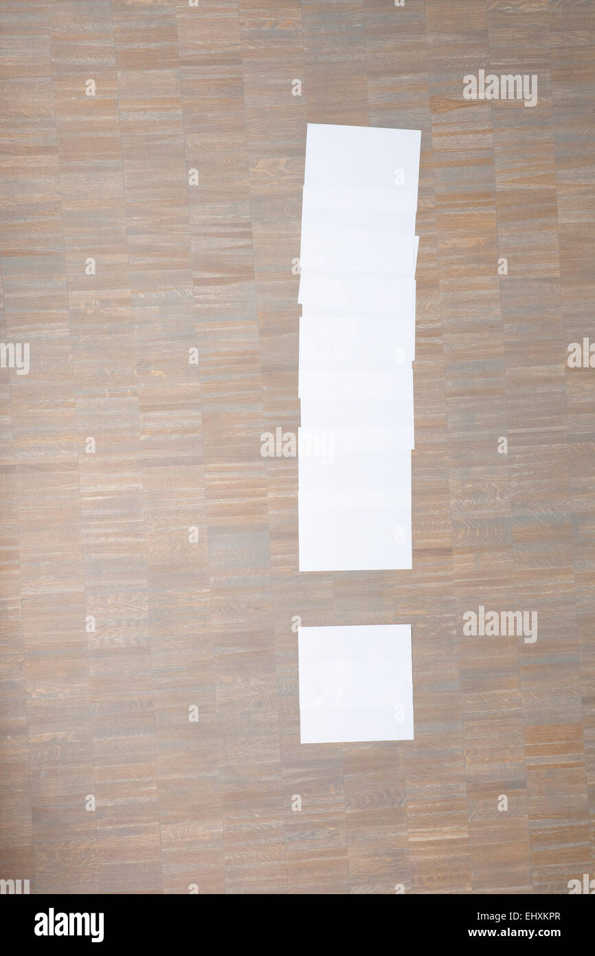 Sheets of paper in shape of exclamation mark on floor Stock Photo - Alamy