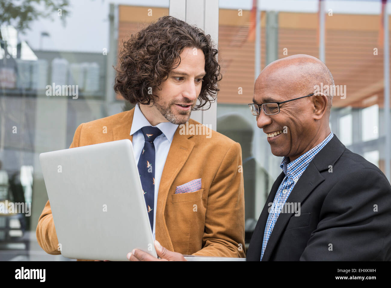 Men two business laptop computer suit meeting Stock Photo - Alamy