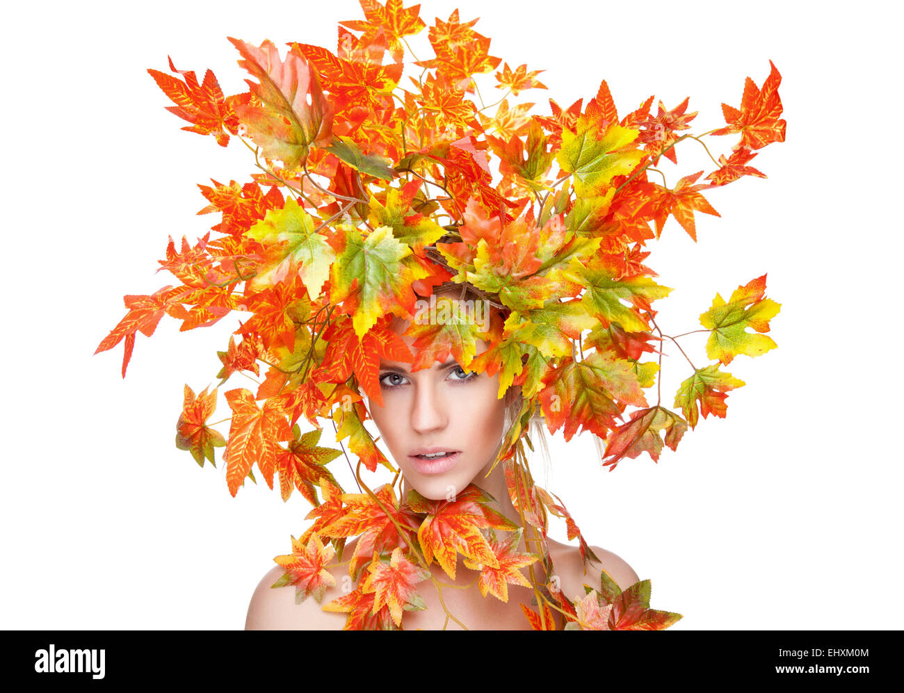 Woman wrapped up in autumn leaves Stock Photo - Alamy