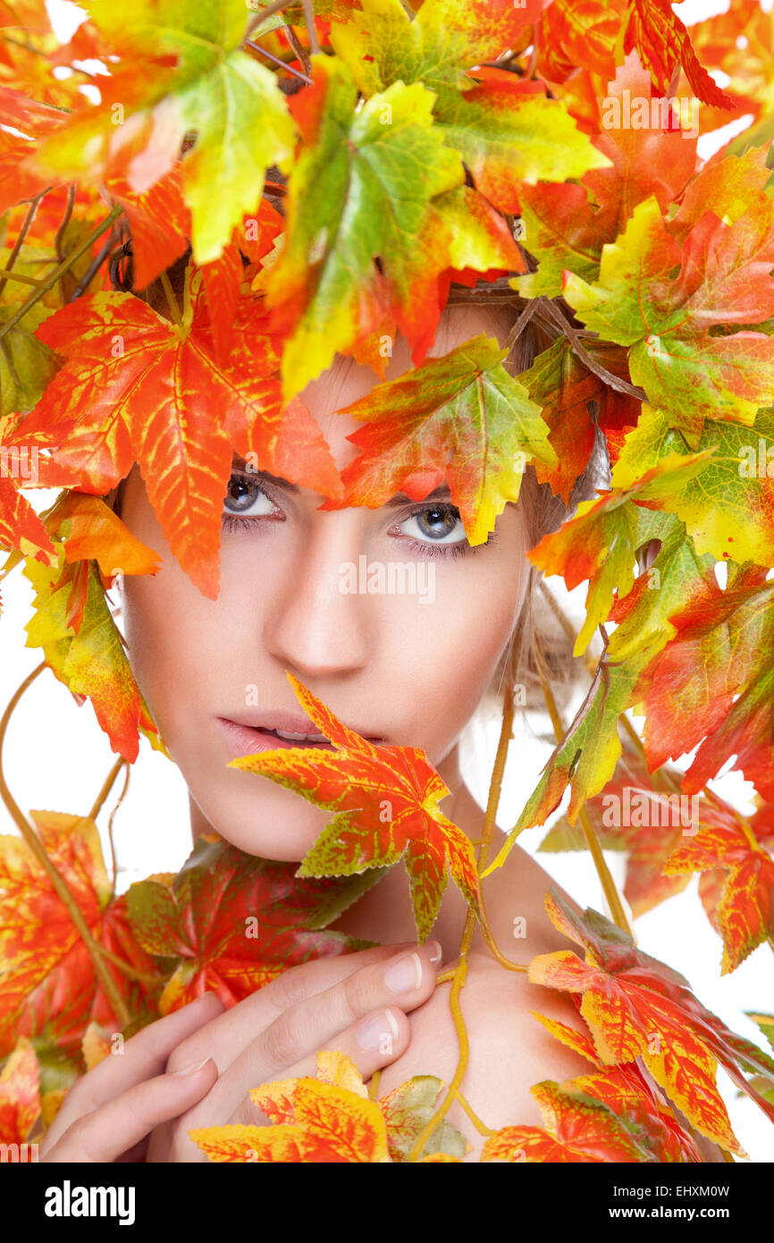 Woman wrapped up in autumn leaves Stock Photo - Alamy