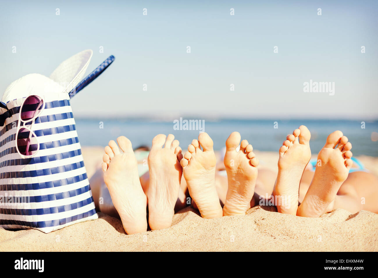 Three women girls lying sunbathing hi-res stock photography and images ...