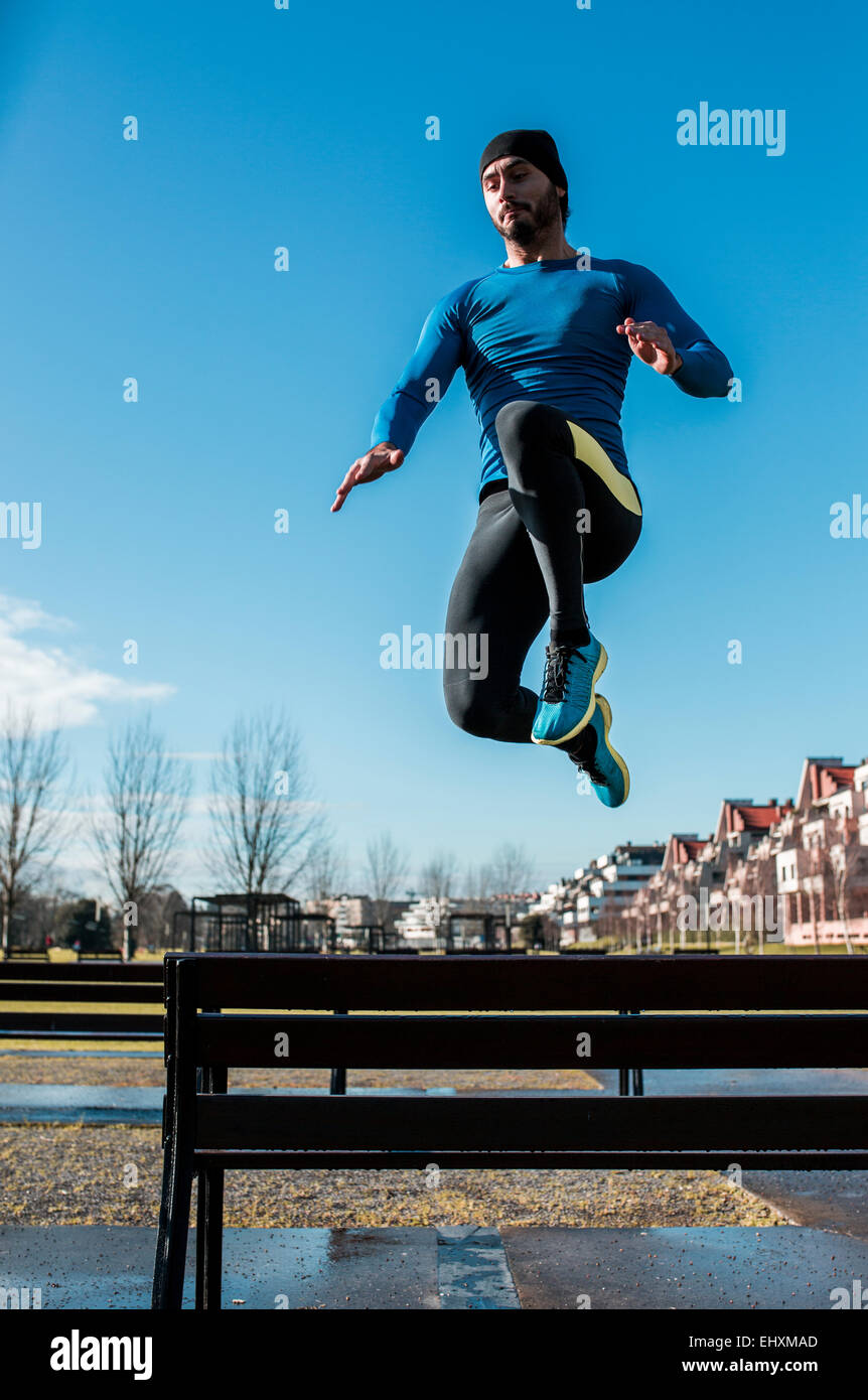 Spain, Gijon, athlete jumping over park bench Stock Photo - Alamy