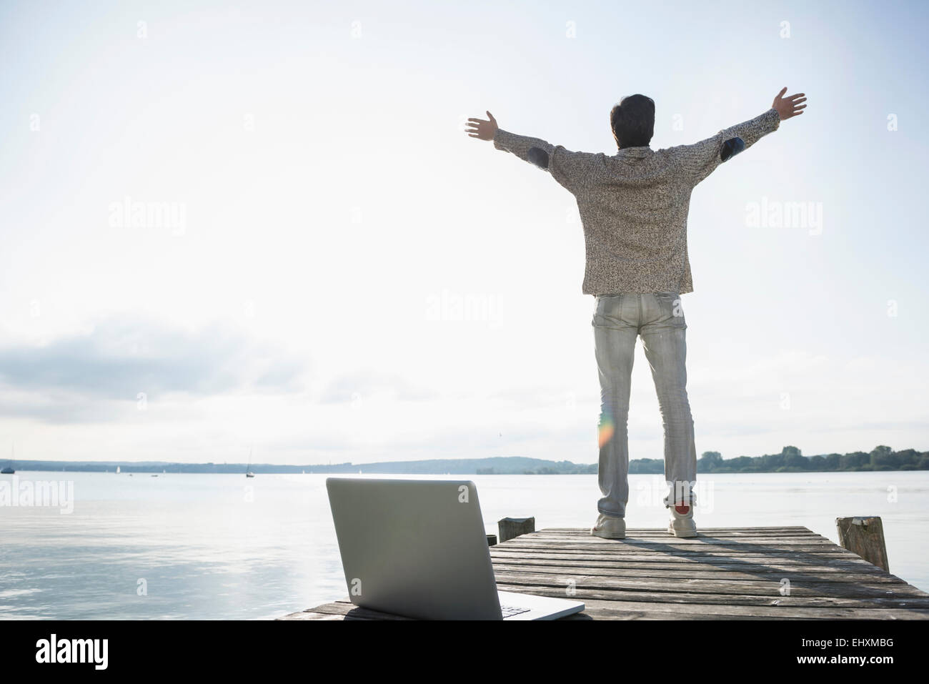 Person from behind standing with laptop hi-res stock photography and ...