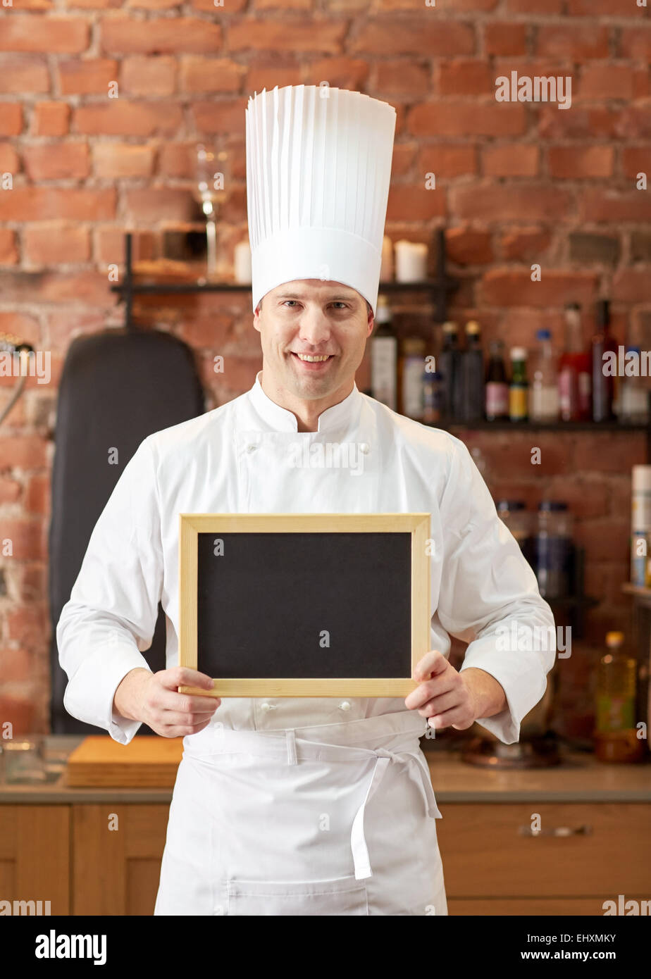 happy male chef with blank menu board in kitchen Stock Photo - Alamy