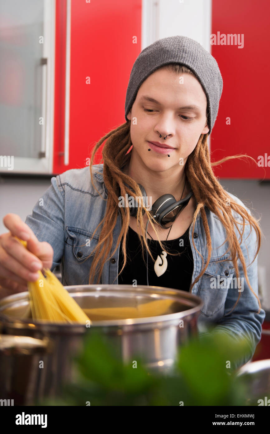 Young man cooking spaghetti in the kitchen, Munich, Bavaria, Germany ...