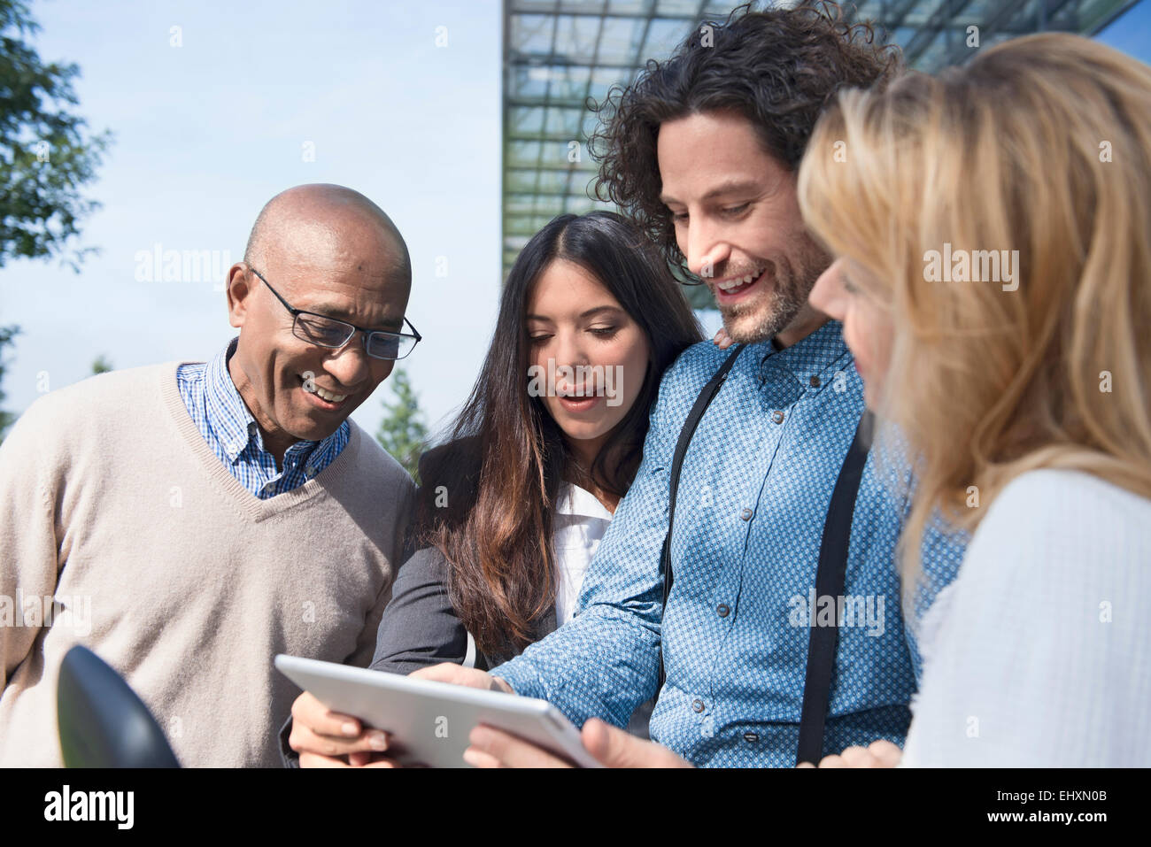 Multicultural group people meeting tablet computer Stock Photo - Alamy