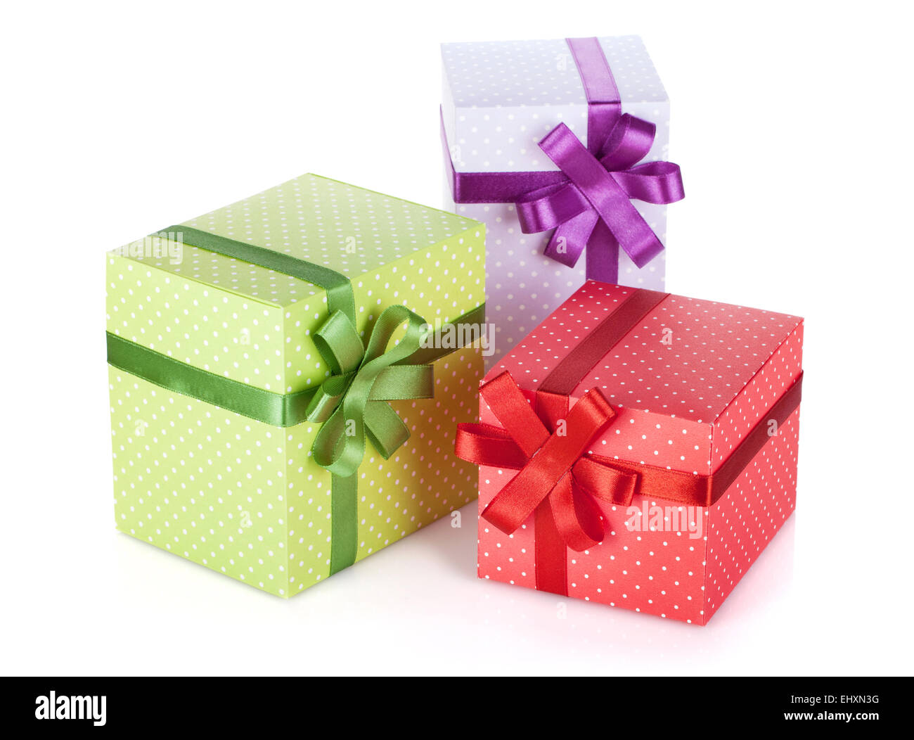 Three colorful gift boxes with ribbon and bow. Isolated on white ...