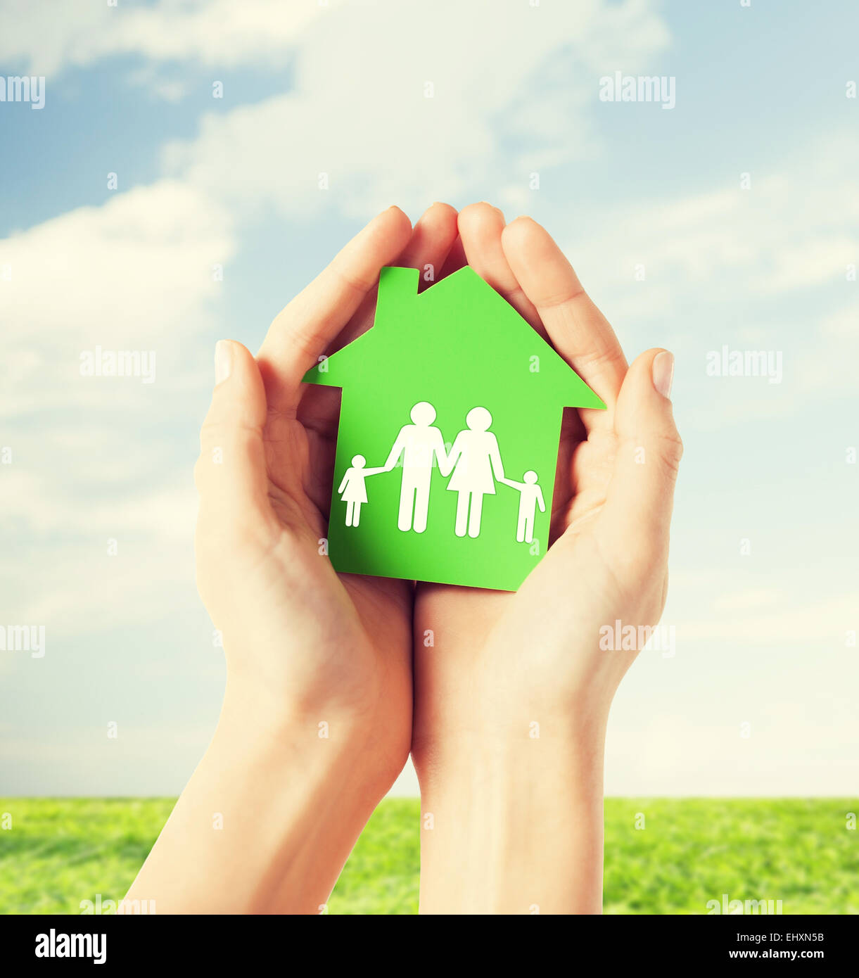 hands holding green house with family Stock Photo - Alamy