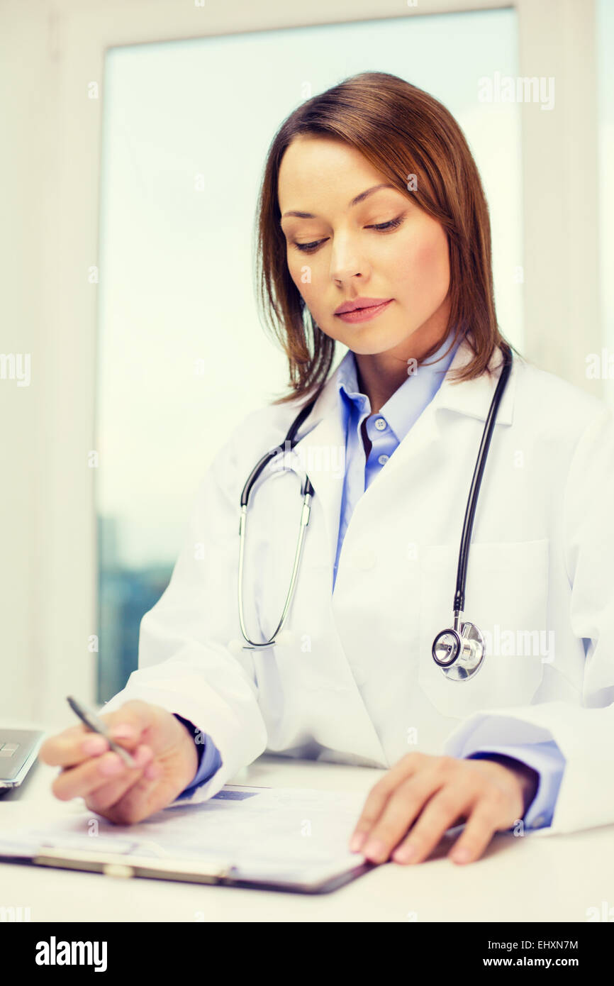busy doctor with laptop computer and clipboard Stock Photo - Alamy