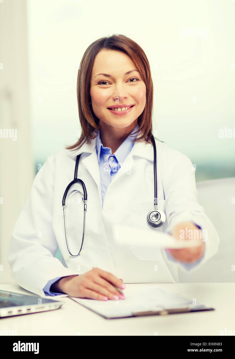 smiling doctor with laptop computer and clipboard Stock Photo - Alamy