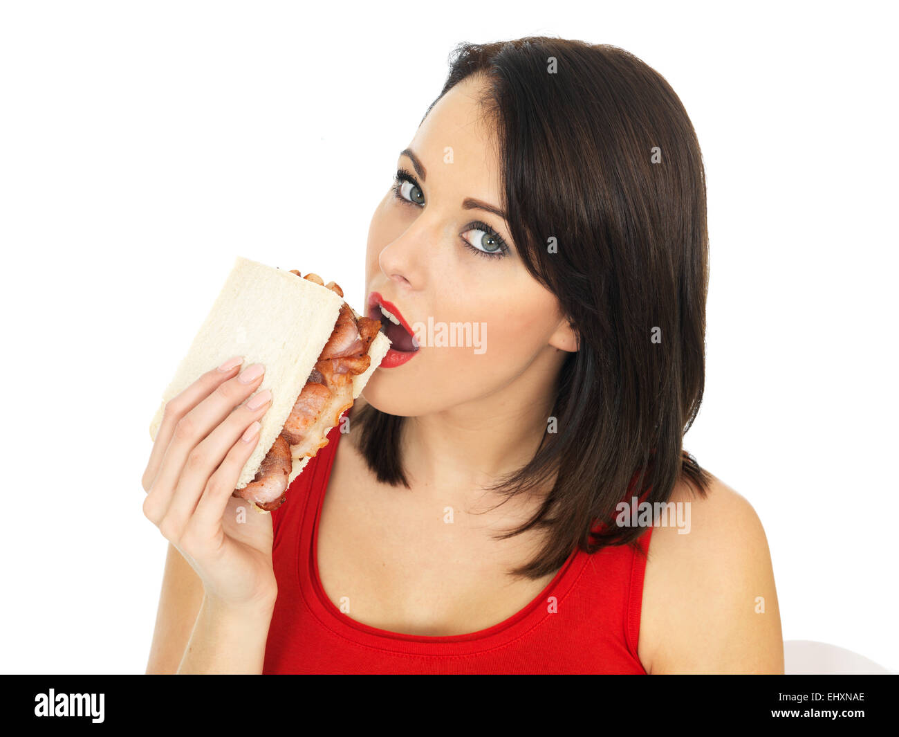 Attractive Young Woman Eating a Bacon Sandwich Stock Photo - Alamy