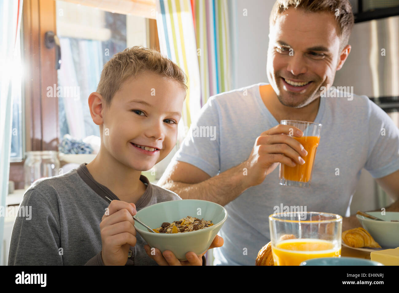 Father and son having breakfast together Stock Photo - Alamy
