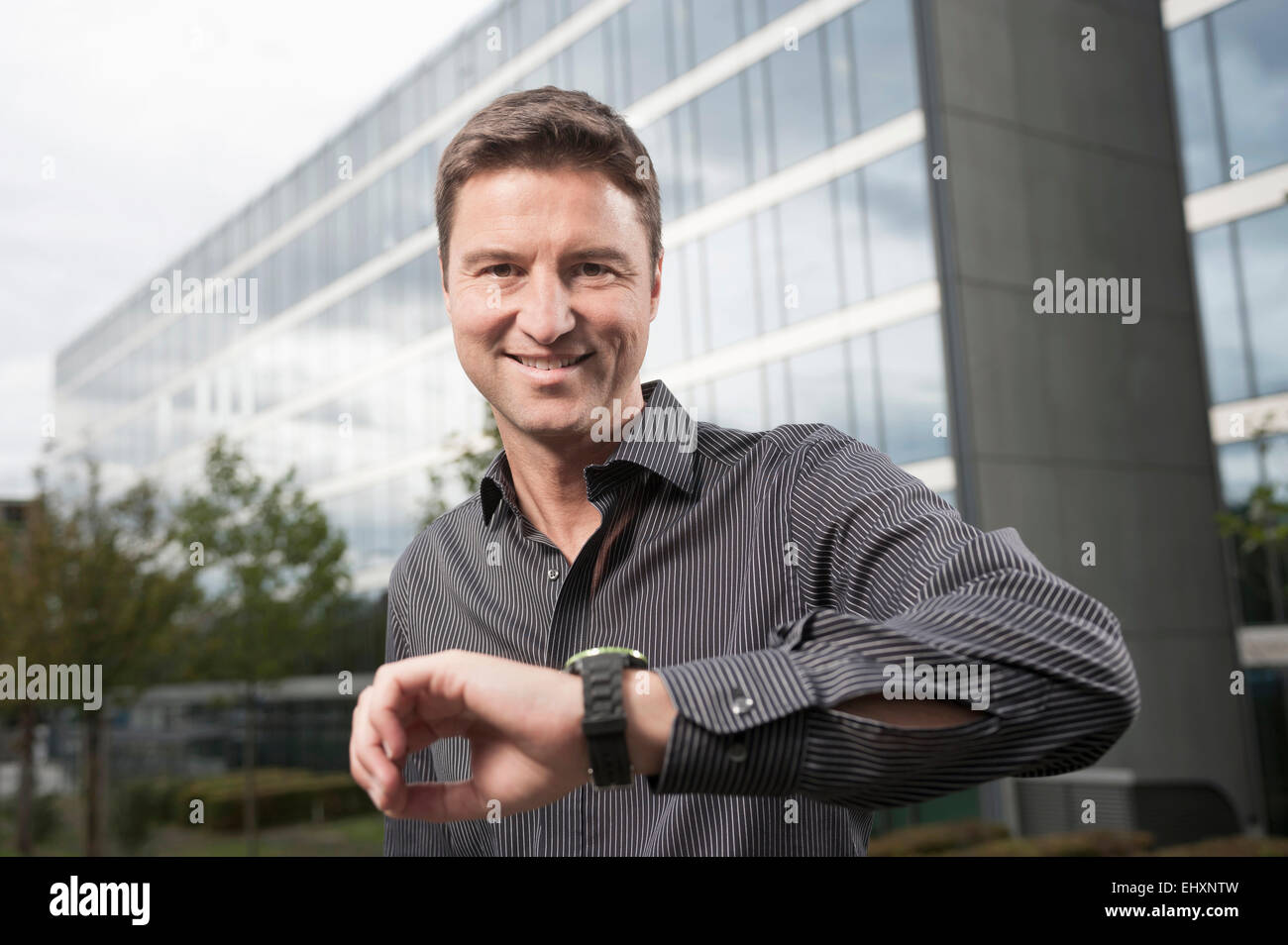 Businessman waiting outside an office building, Bavaria, Germany Stock ...