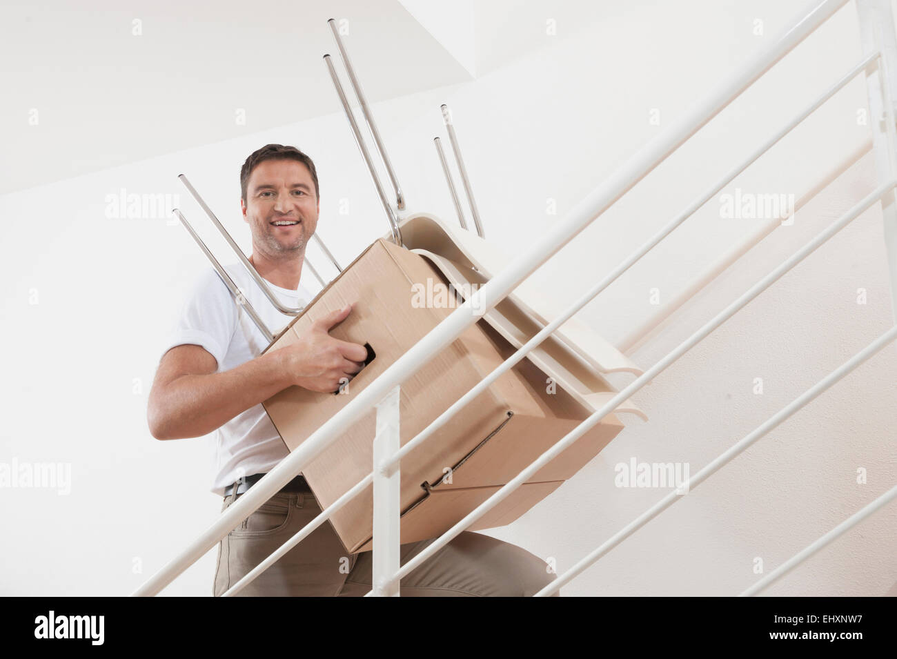 Man walking up apartment stairs hi-res stock photography and images - Alamy