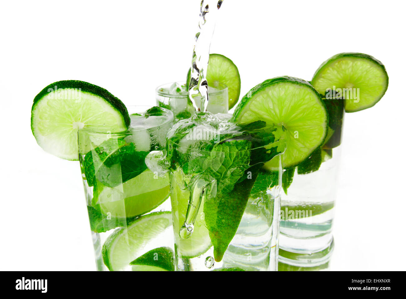 Making mojito cocktail with lime and mint isolated on white background ...