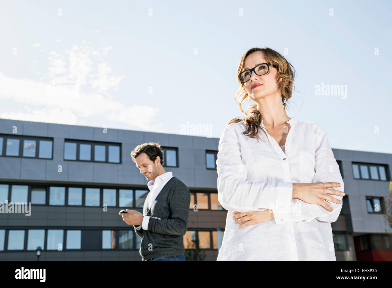 Two business people waiting Stock Photo - Alamy