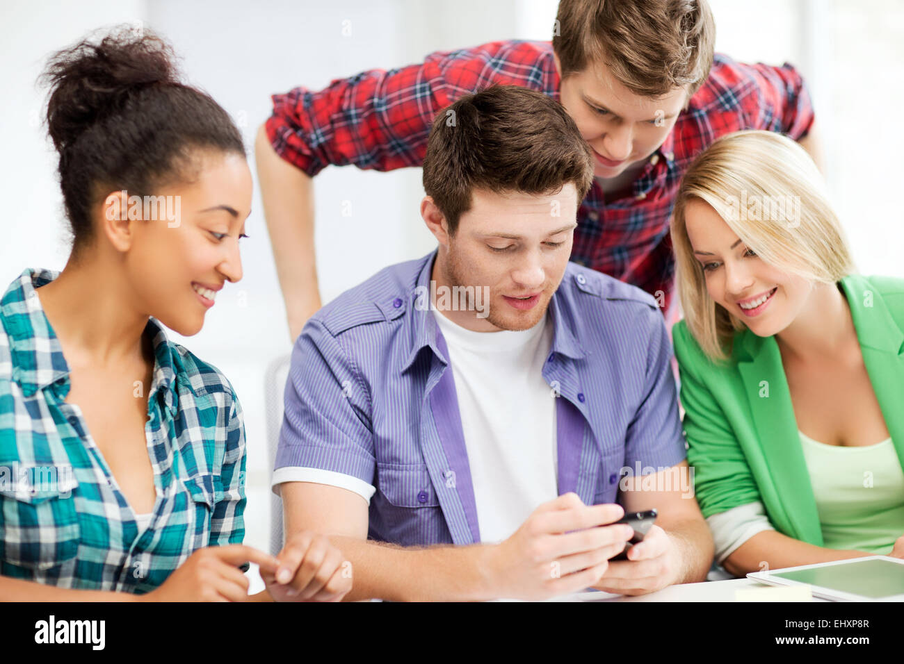 students looking at smartphone at school Stock Photo - Alamy