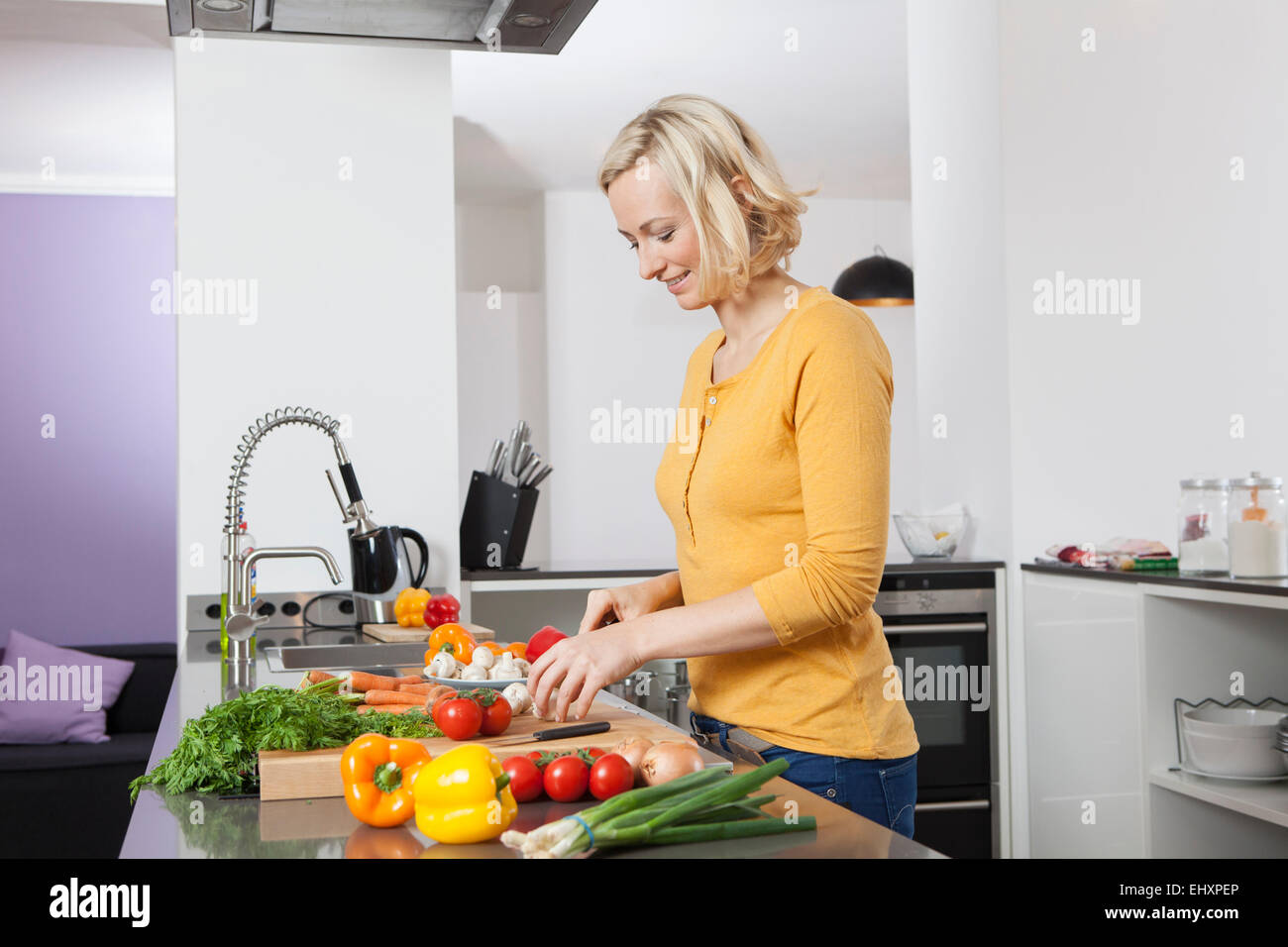 Woman cooking in kitchen Stock Photo - Alamy
