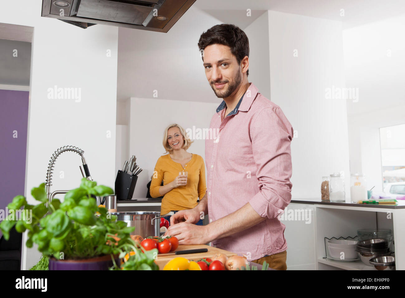 Couple cooking in kitchen Stock Photo - Alamy