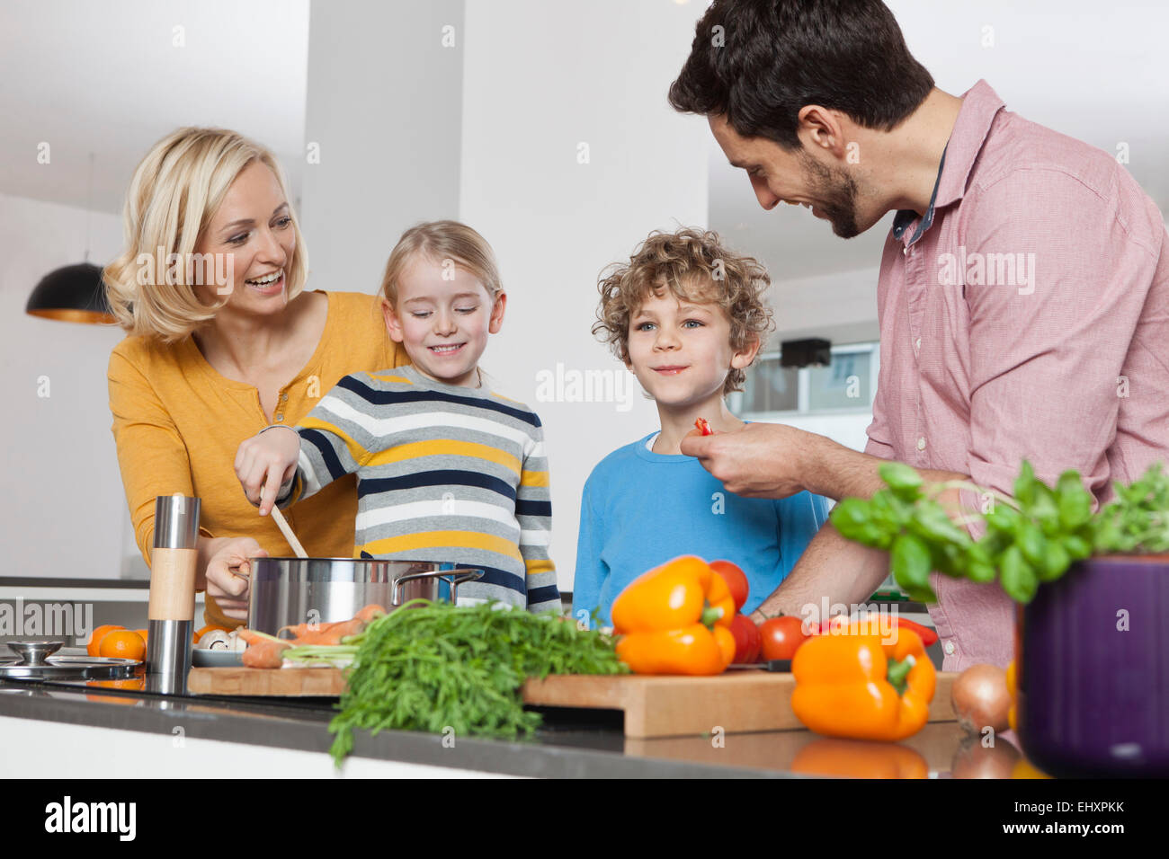 Family cooking in kitchen Stock Photo - Alamy