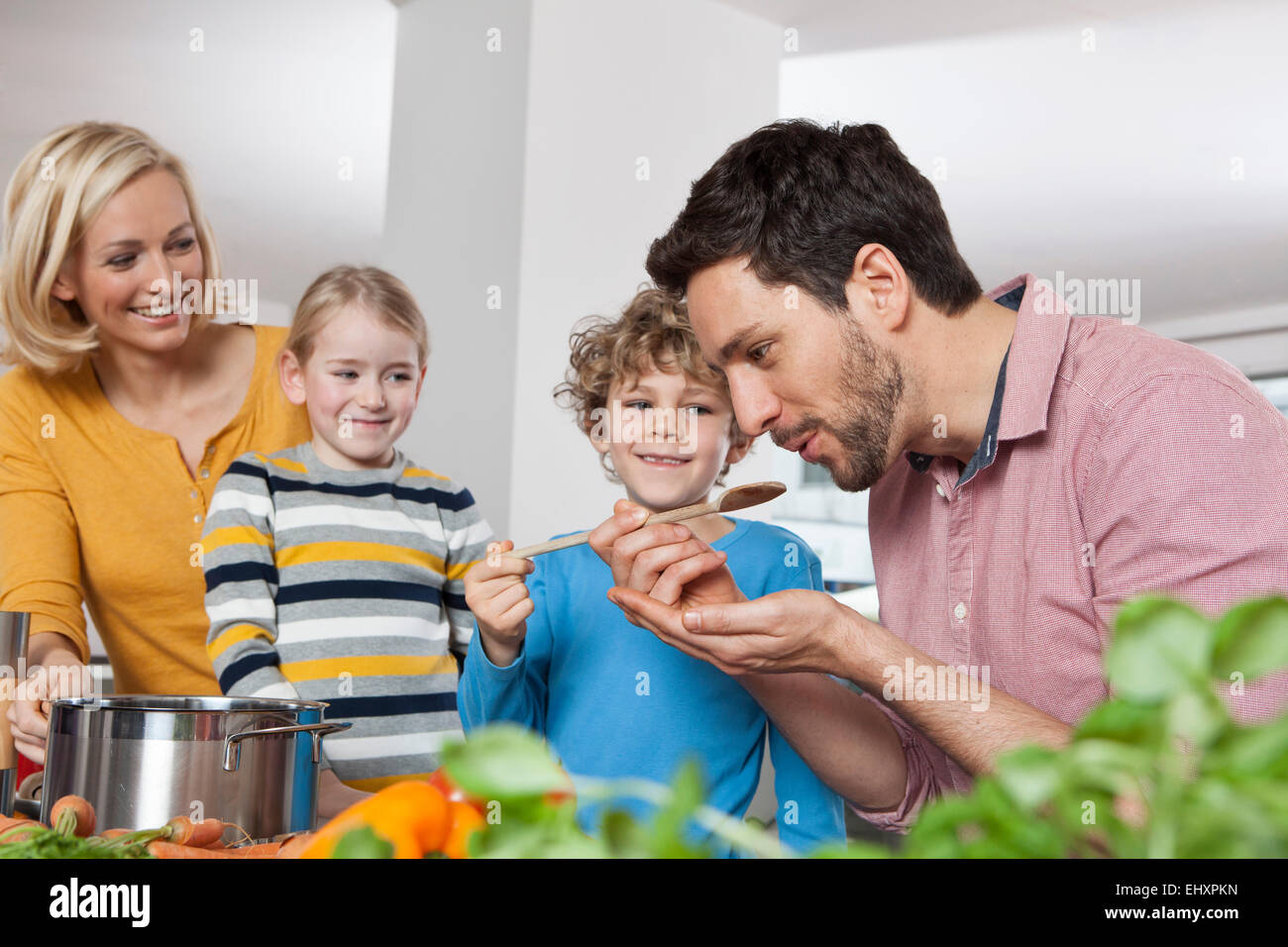 Family cooking in kitchen Stock Photo - Alamy