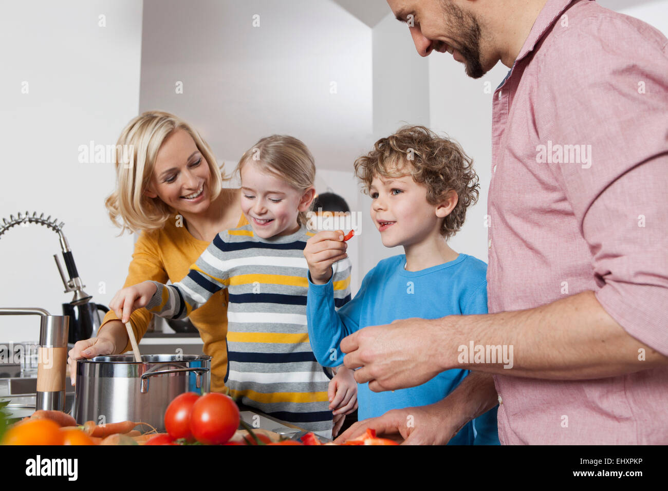 Family cooking in kitchen Stock Photo - Alamy