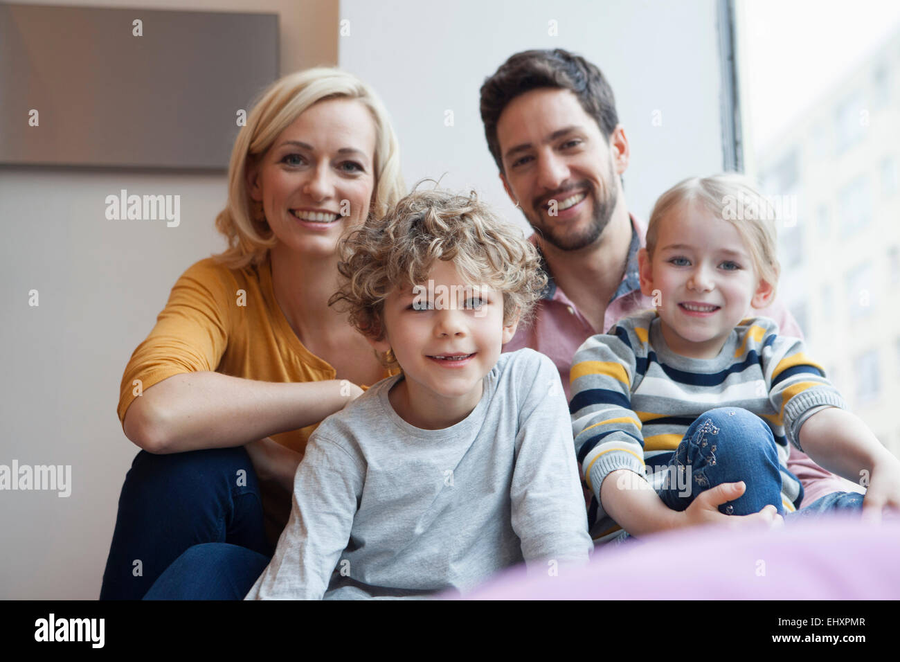 Portrait of happy family at the window Stock Photo - Alamy