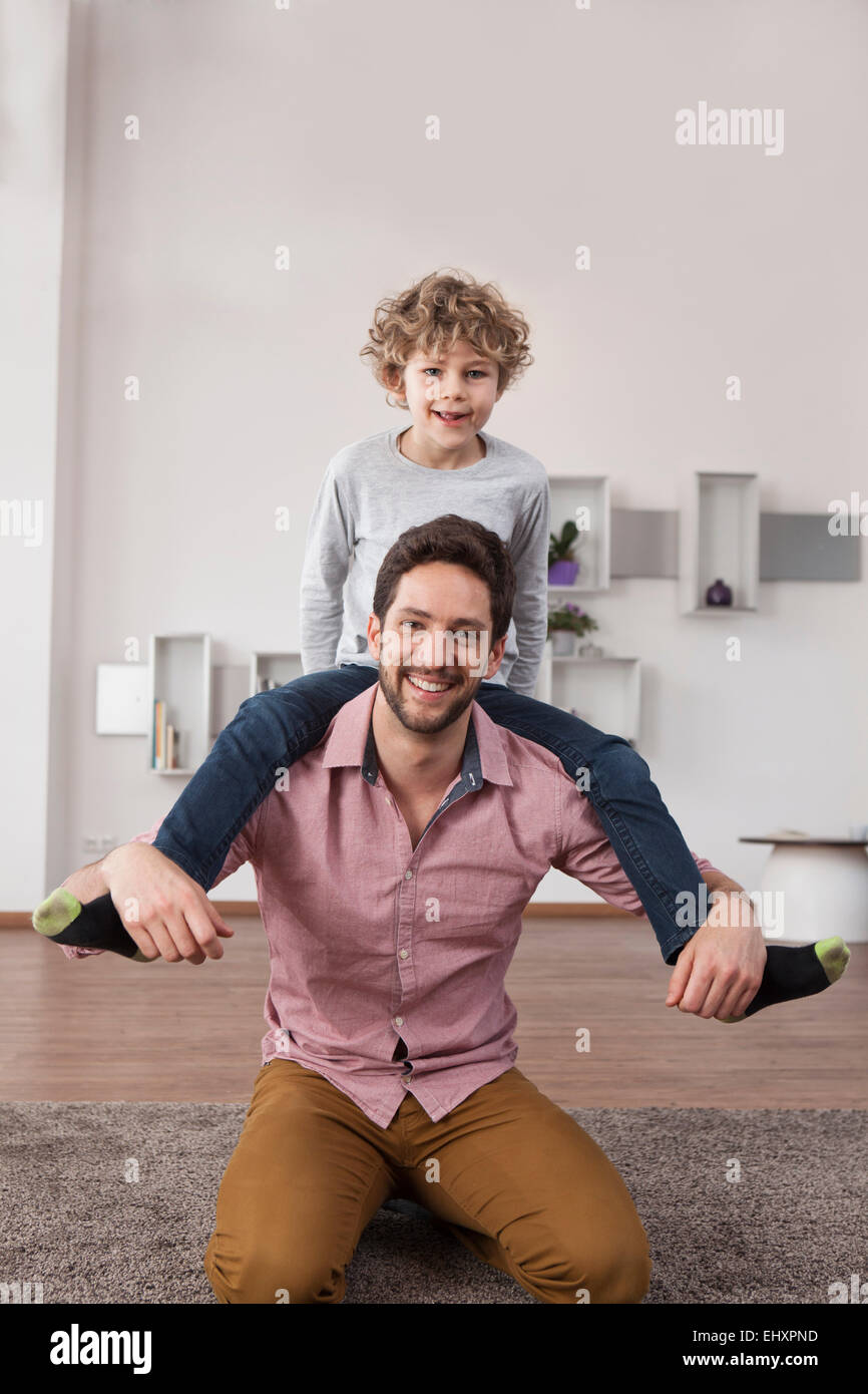 Father carrying son on shoulders Stock Photo - Alamy