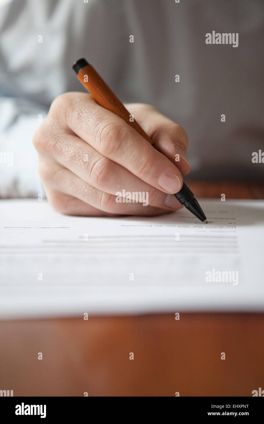 Man signing document Stock Photo - Alamy