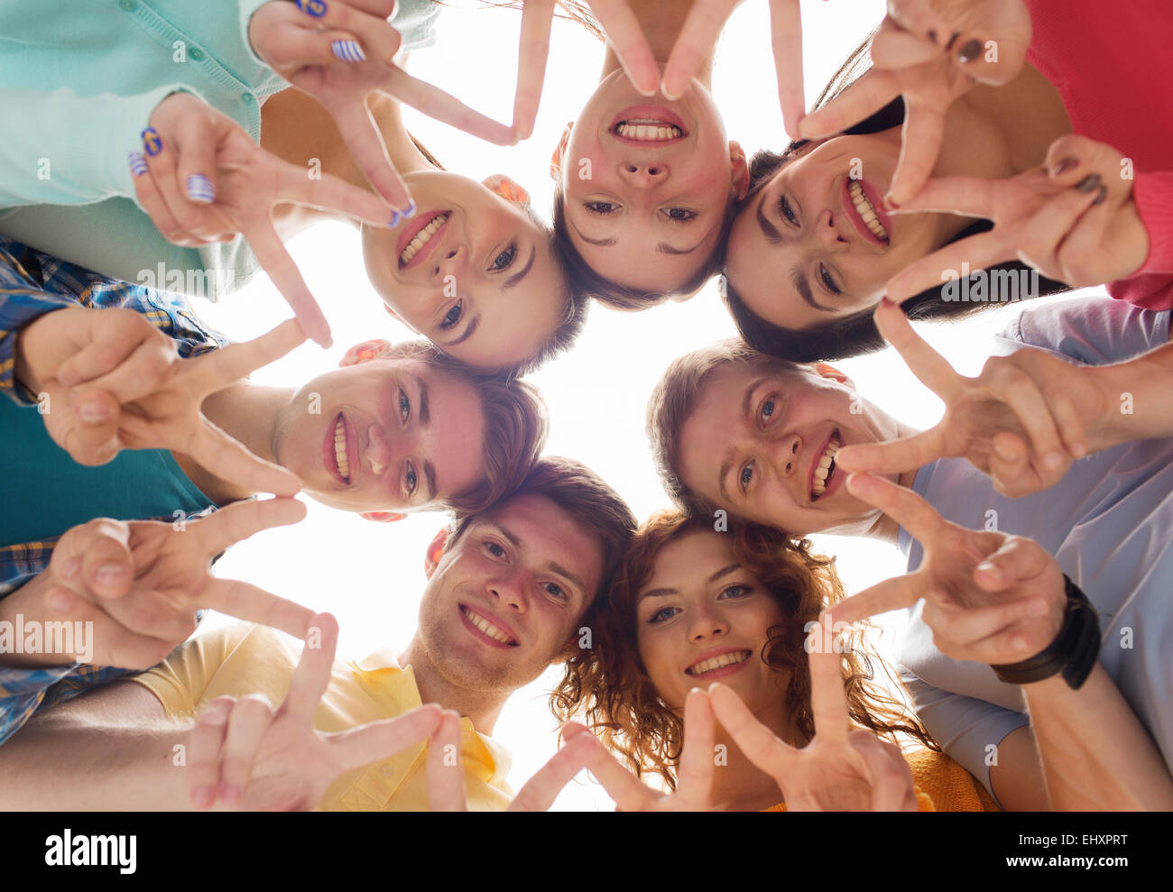 group of smiling teenagers showing victory sign Stock Photo - Alamy