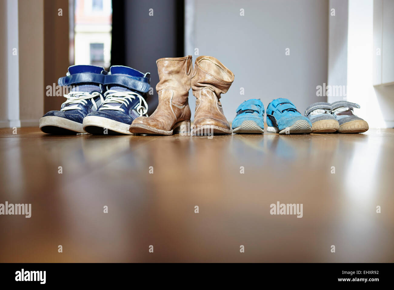 Row of shoes of a family Stock Photo - Alamy