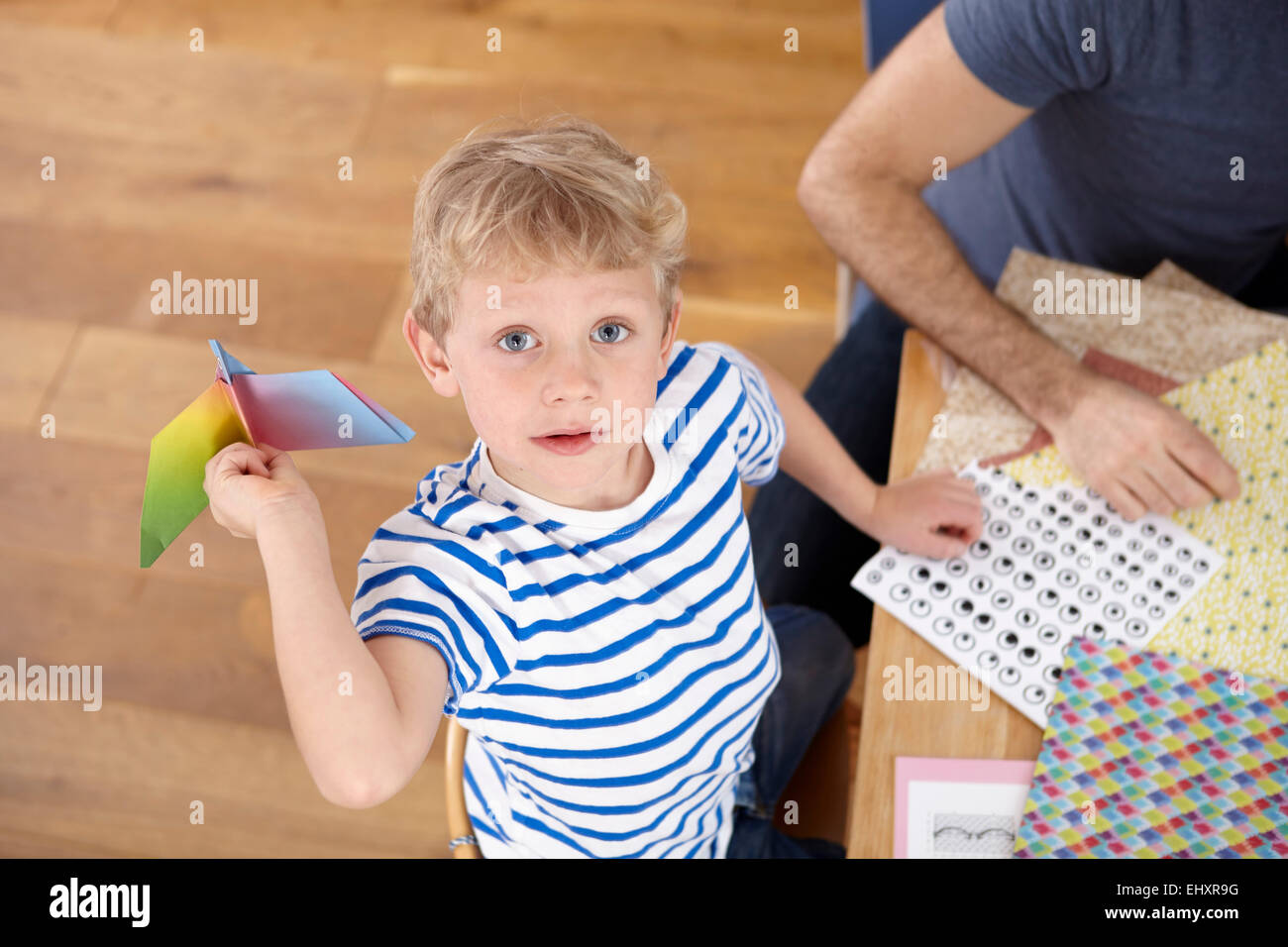 Little boy with colourful paper plane Stock Photo - Alamy