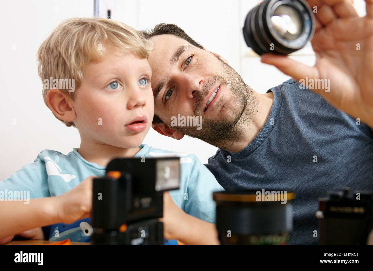 Father explaining analogue camera to son Stock Photo - Alamy