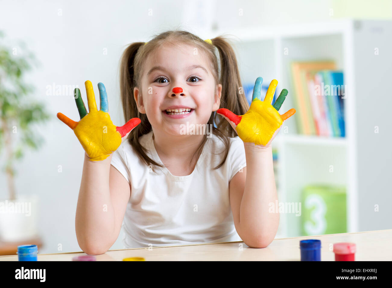 Kid girl showing painted hands hi-res stock photography and images - Alamy