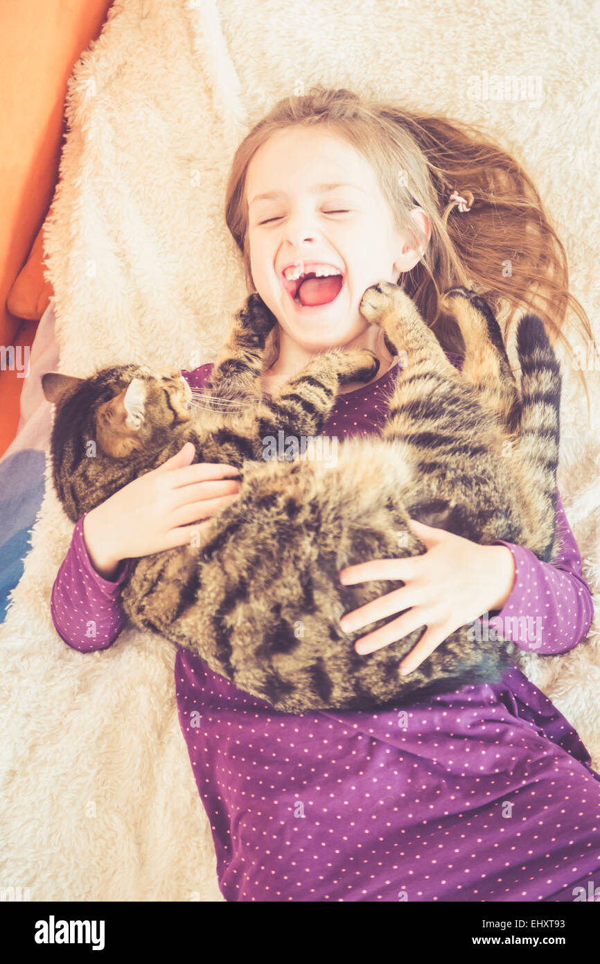 Girl playing with cat hi-res stock photography and images - Alamy