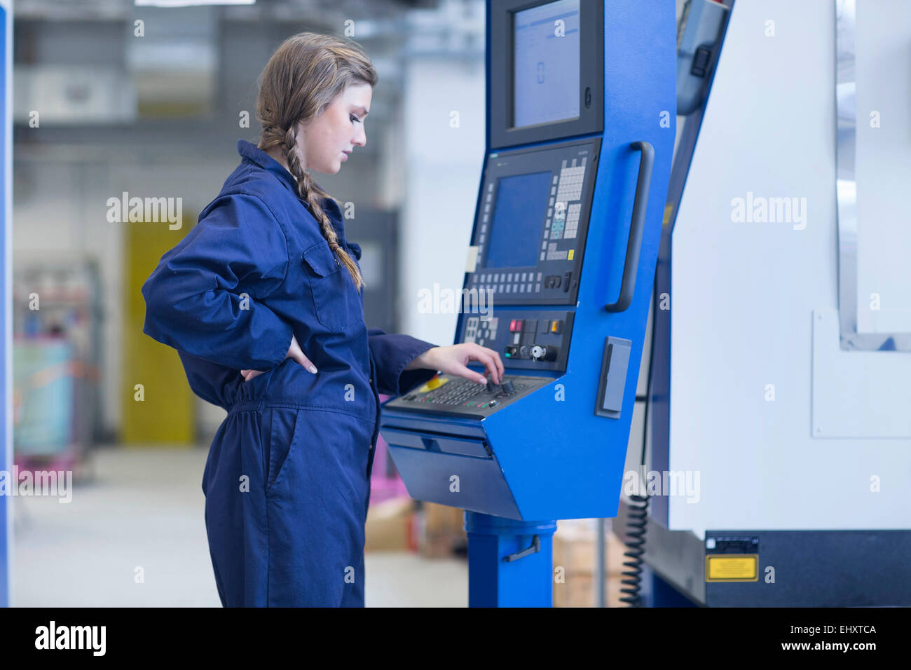 Technician in factory hall working at milling machine Stock Photo - Alamy