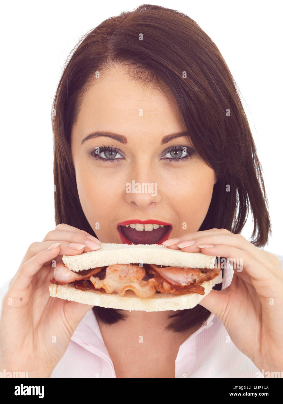 Attractive Young Woman Eating a Bacon Sandwich Stock Photo - Alamy