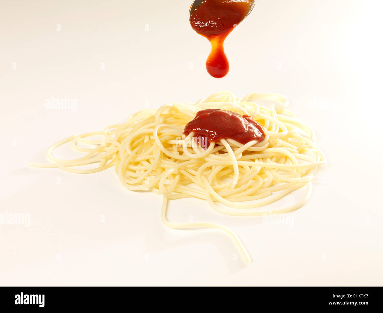 Tomato sauce dropping on spaghetti Stock Photo - Alamy